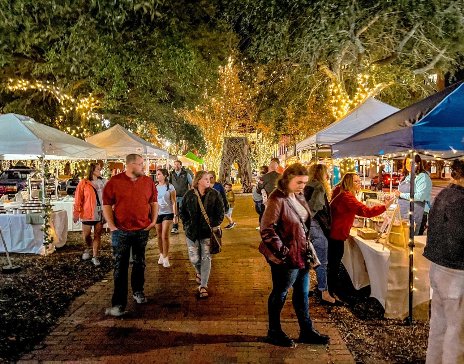 A busy holiday night at Pensacola Winterfest featuring stalls of yummy foods