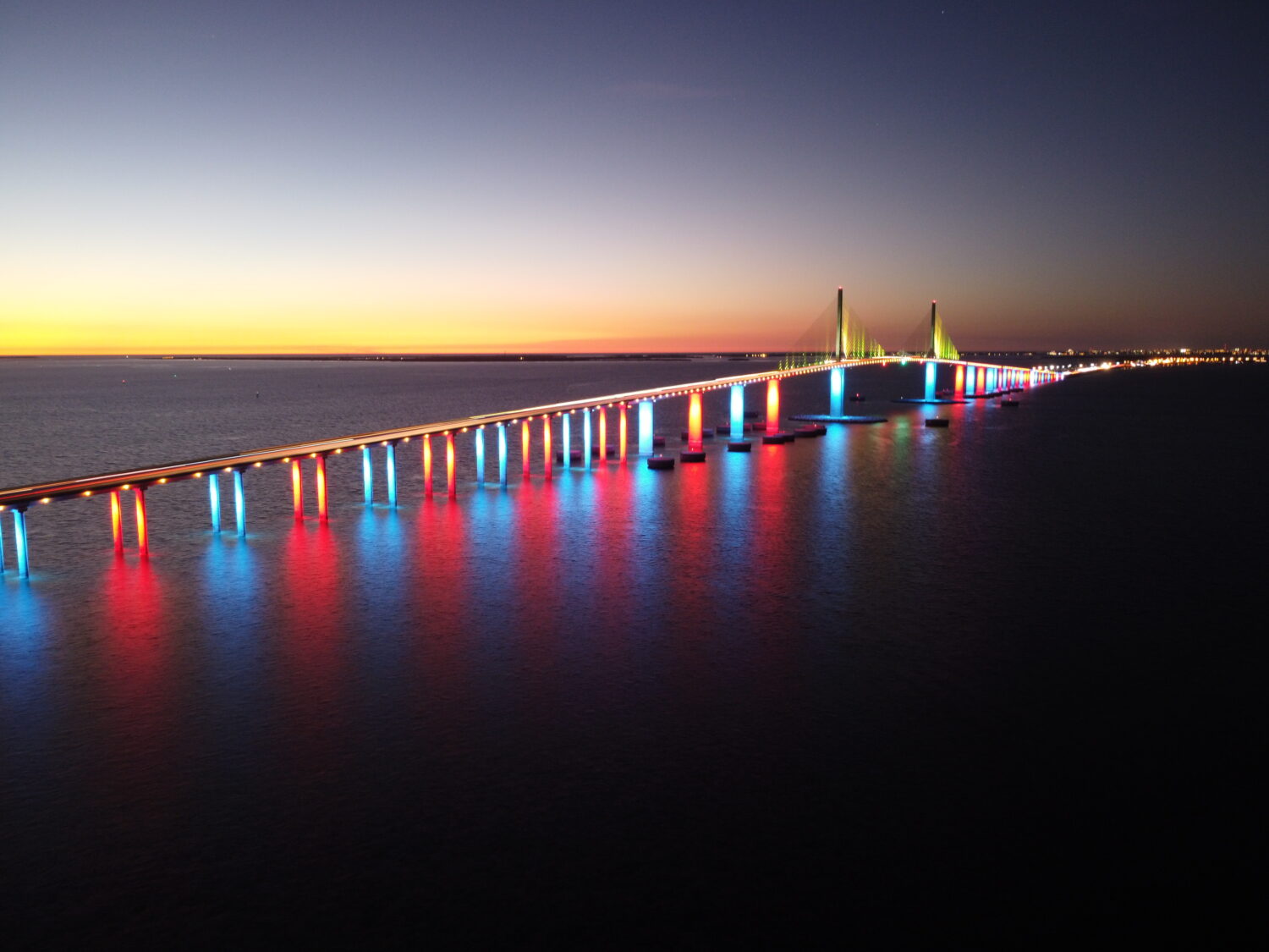 A mesmerizing image of the bridge with colorful lights at night
