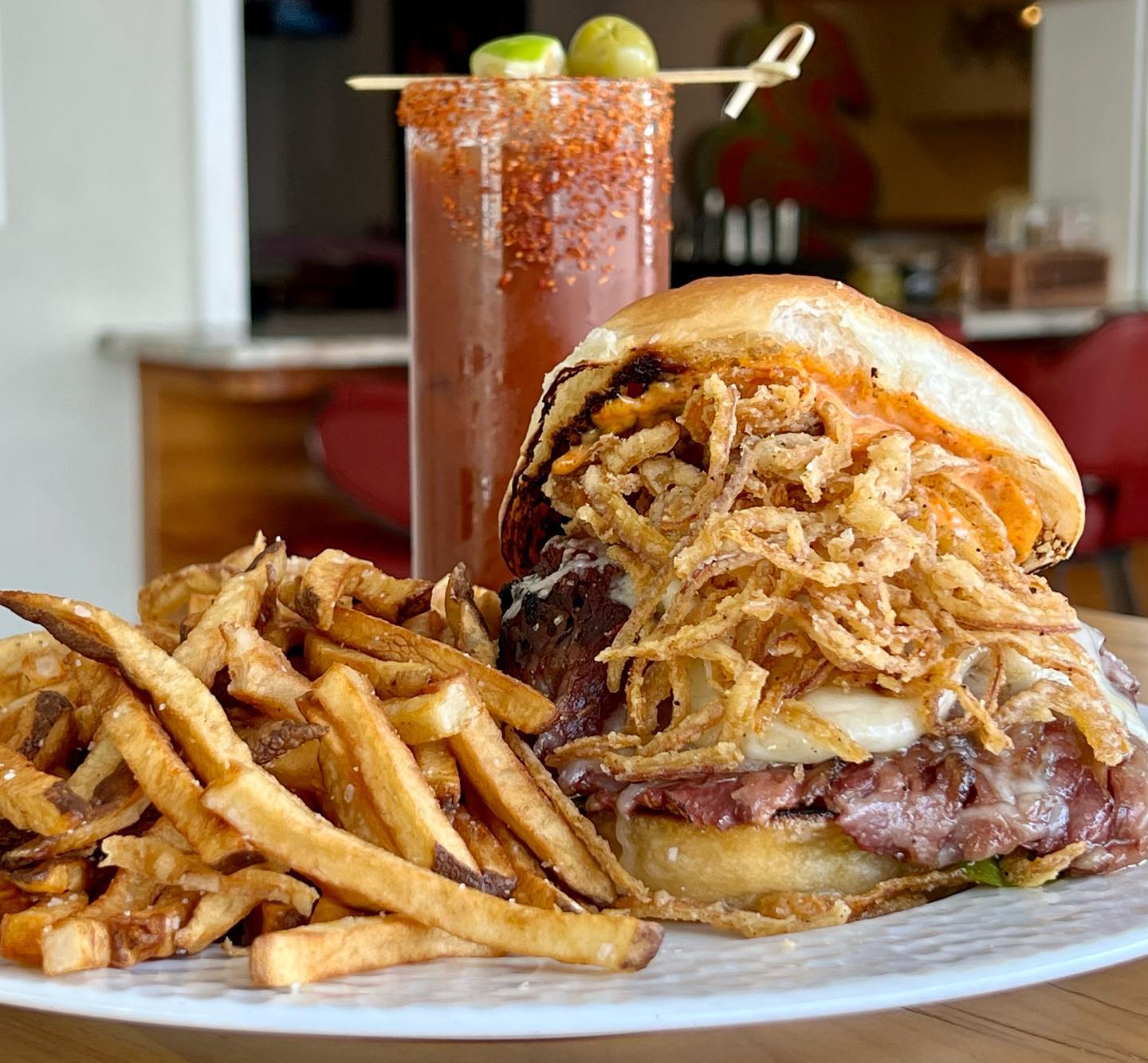 A plate of well crafted loaded burger with fries