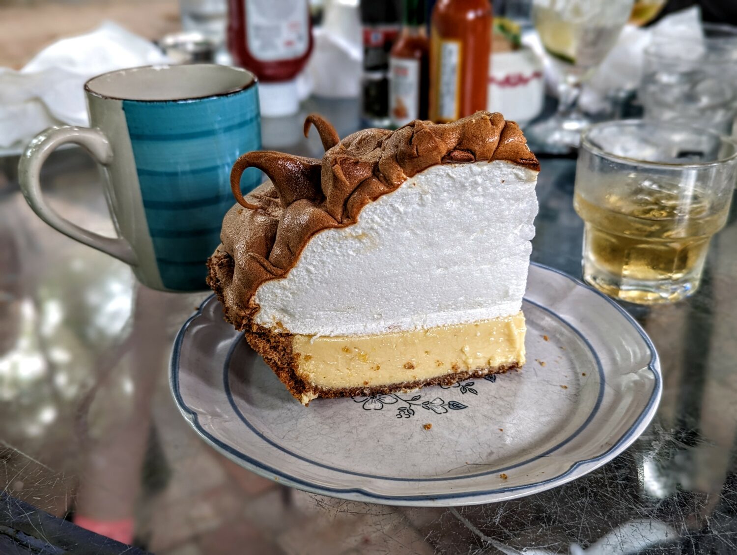 A slice of key lime pie with generous toasted meringue finish on top