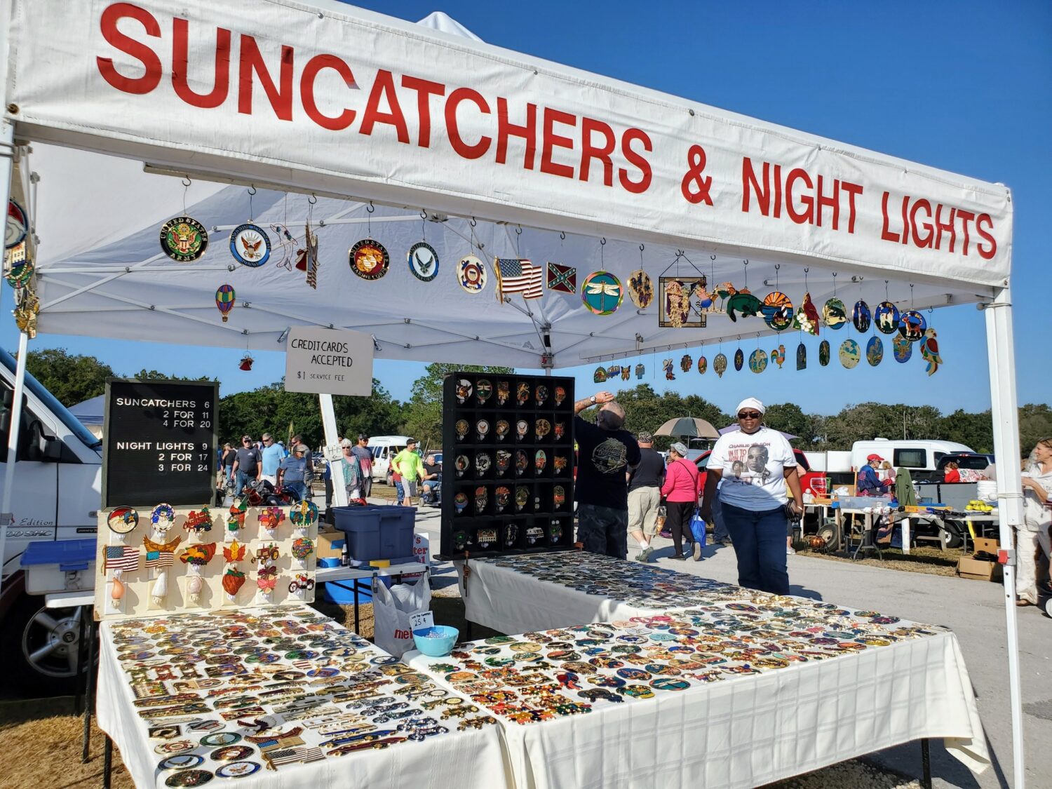 A stall full of sun catchers and night lights.