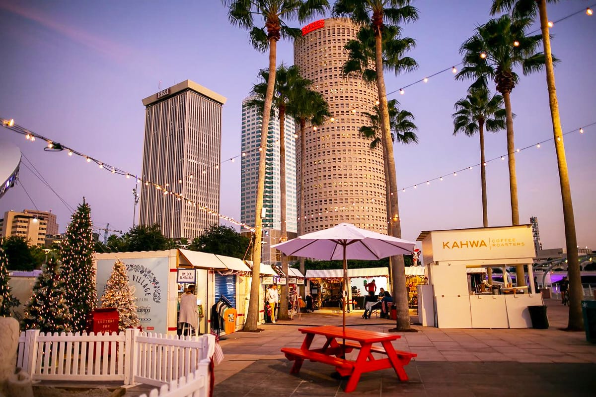 An array of food stalls lining the park offering delicious holiday treats