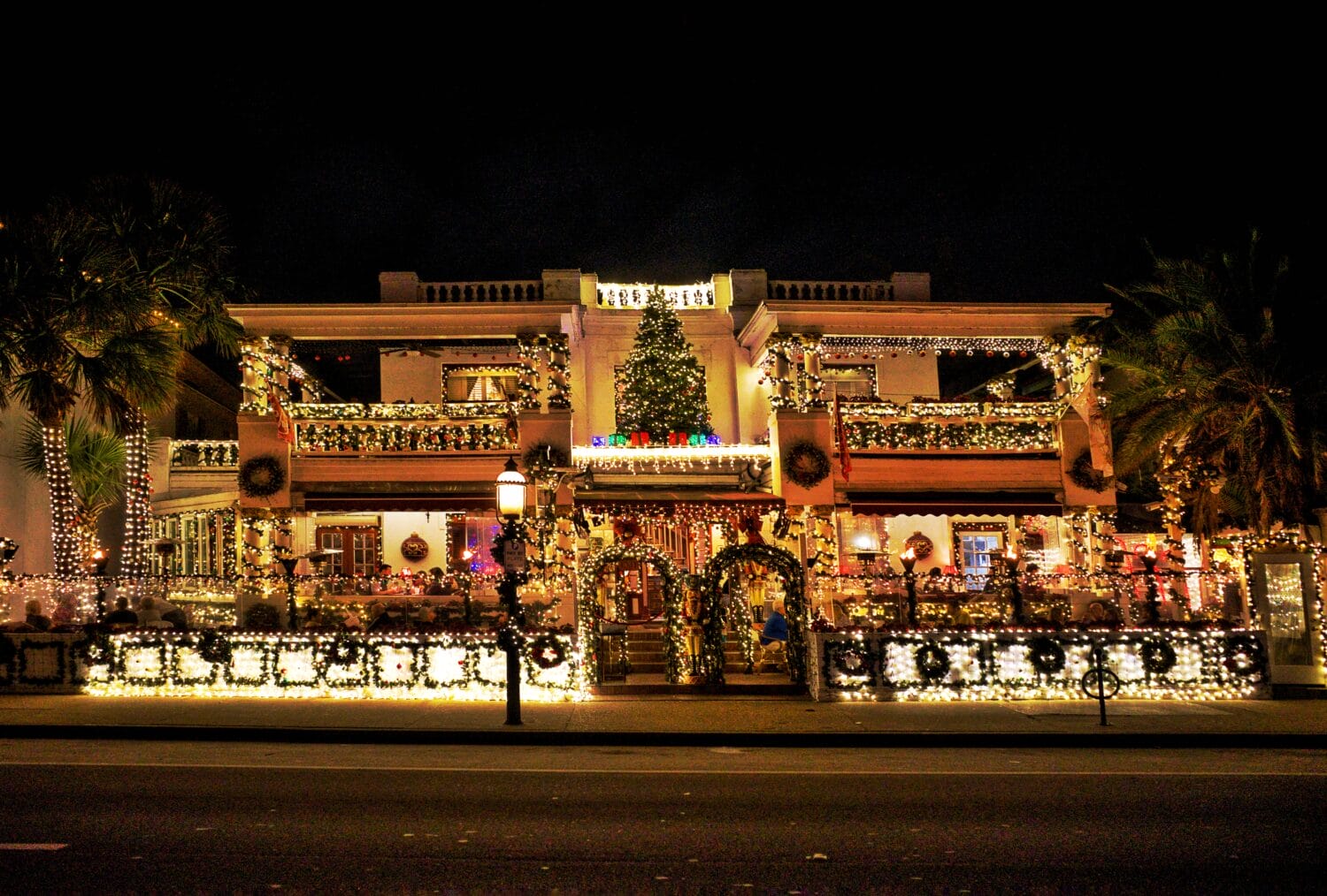 An exterior of a building full of dazzling holiday lights.