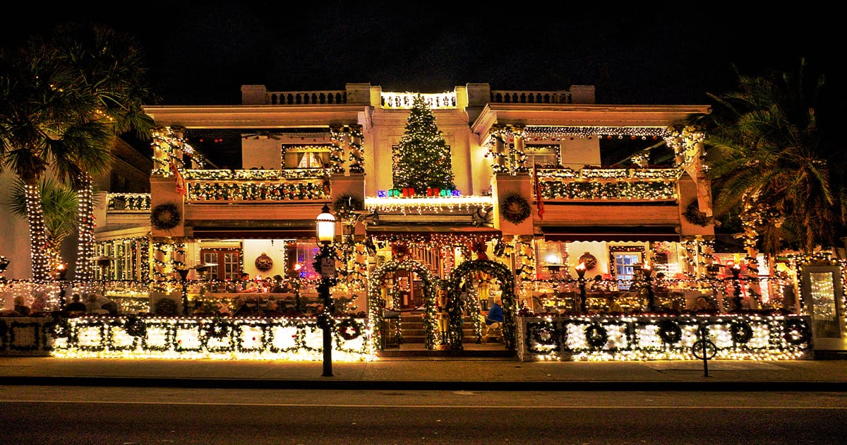 An exterior of a building full of dazzling holiday lights.