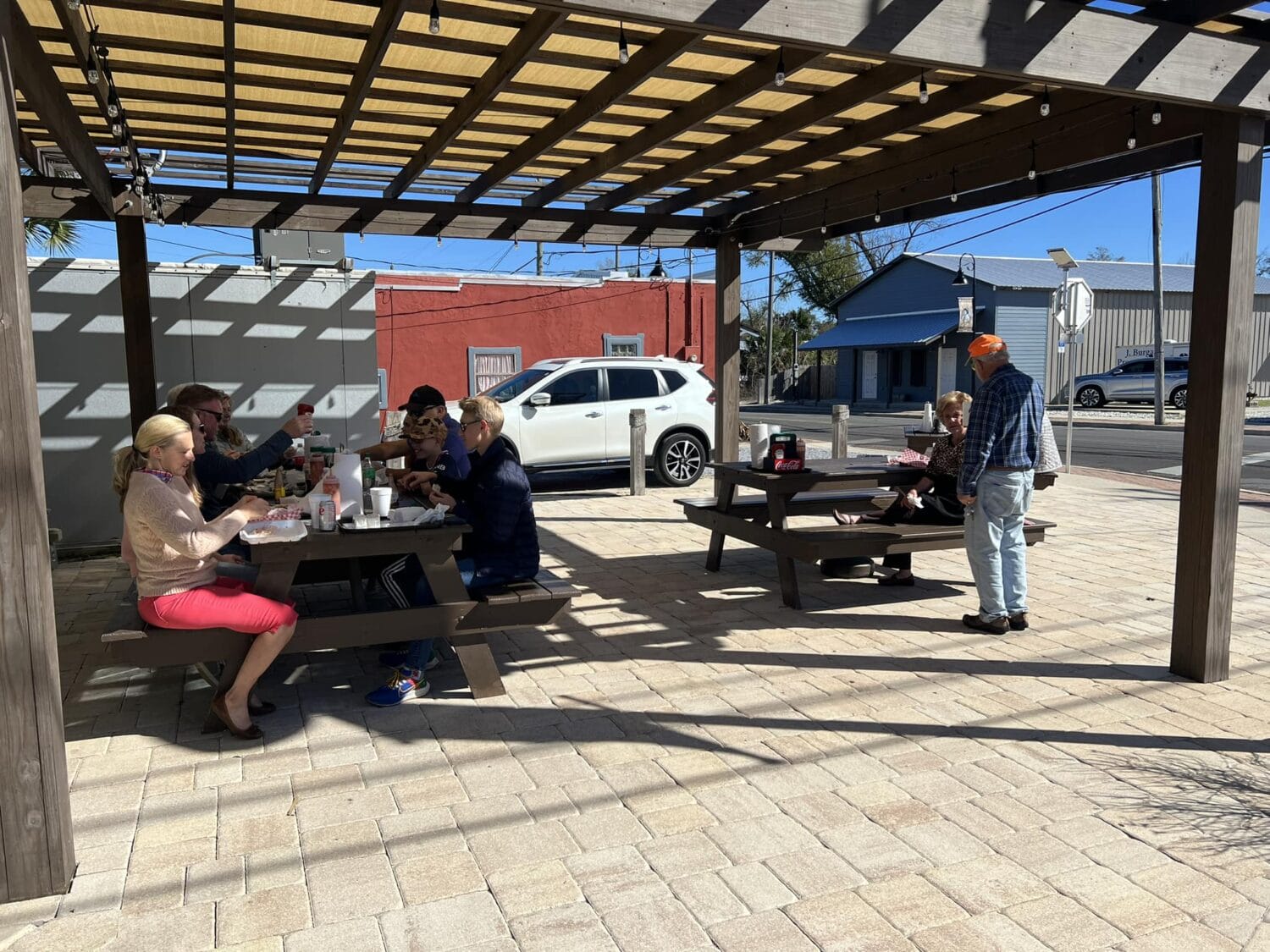 A photo of the restaurant's outside dining area with people enjoying their meal.