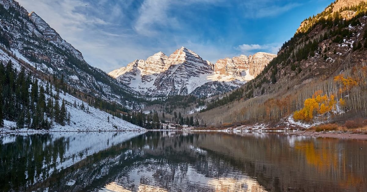 A stunning view of Aspen's peaks, lake, and landscapes.