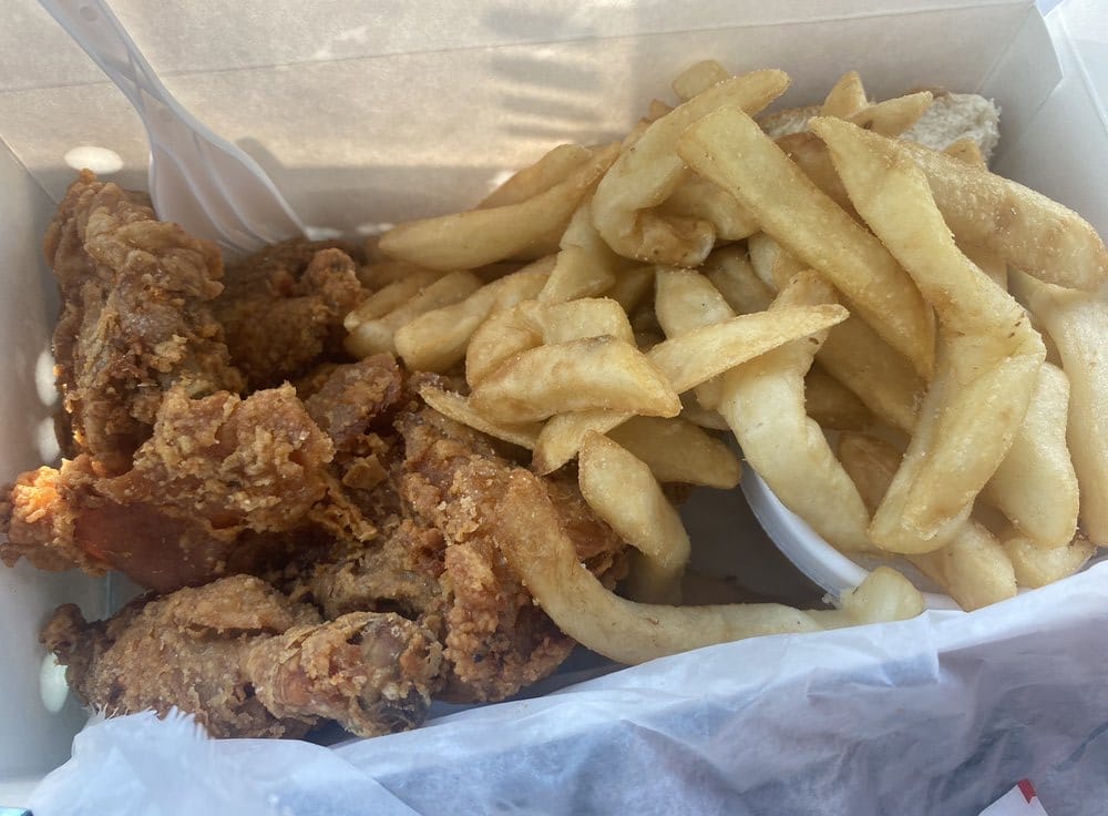 A box of fried chicken and crispy fries.