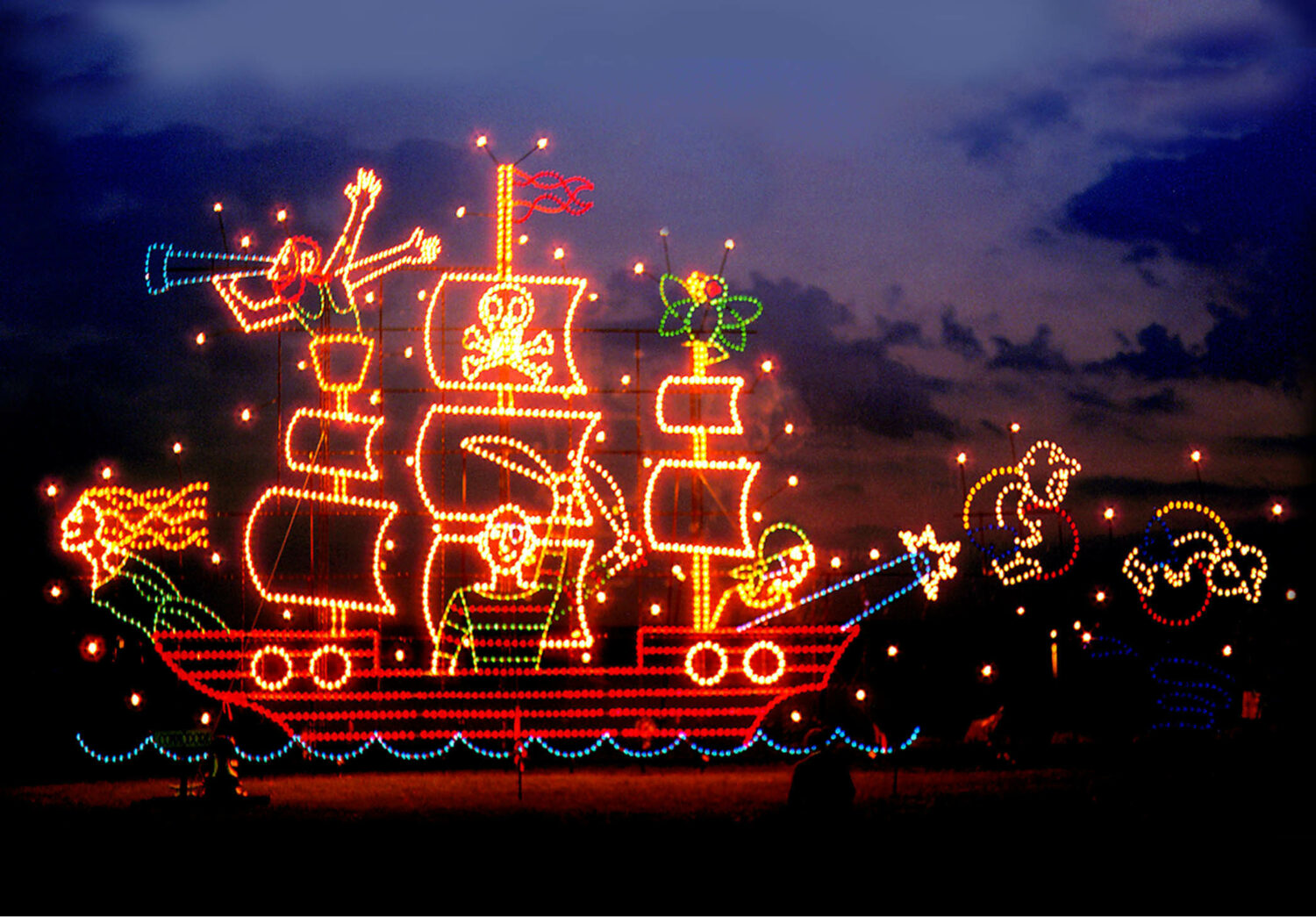 a boat design adorned with bright holiday lights