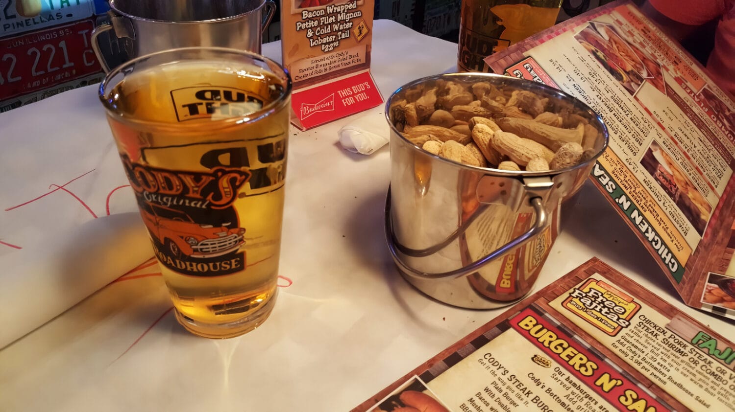 a bucket of peanuts and a a glass of beer