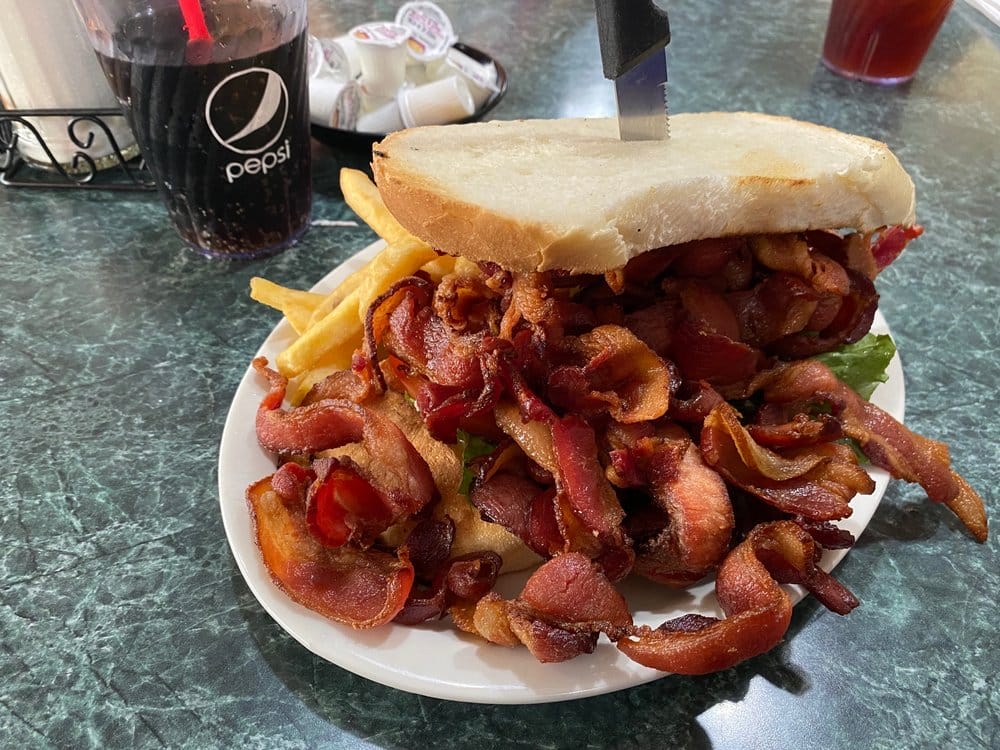 A classic diner meal showcasing a BLT sandwich loaded with bacon