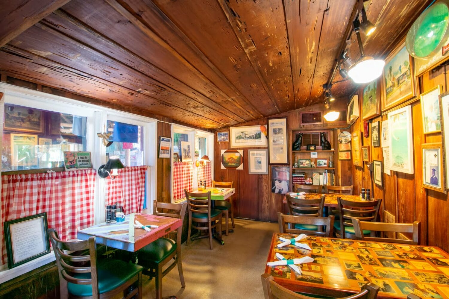 a cozy interior of harry and the natives with checkered tablecloths and warm lighting