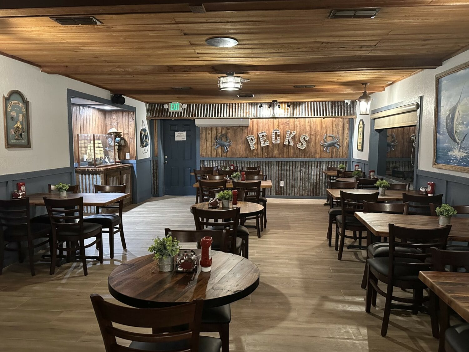 a cozy nautical themed restaurant interior with wooden tables and maritime decor