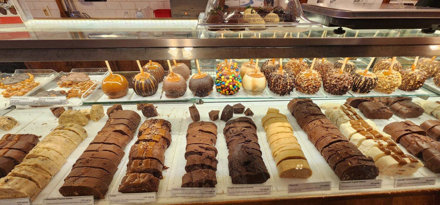 A display of freshly made fudge and caramel apples