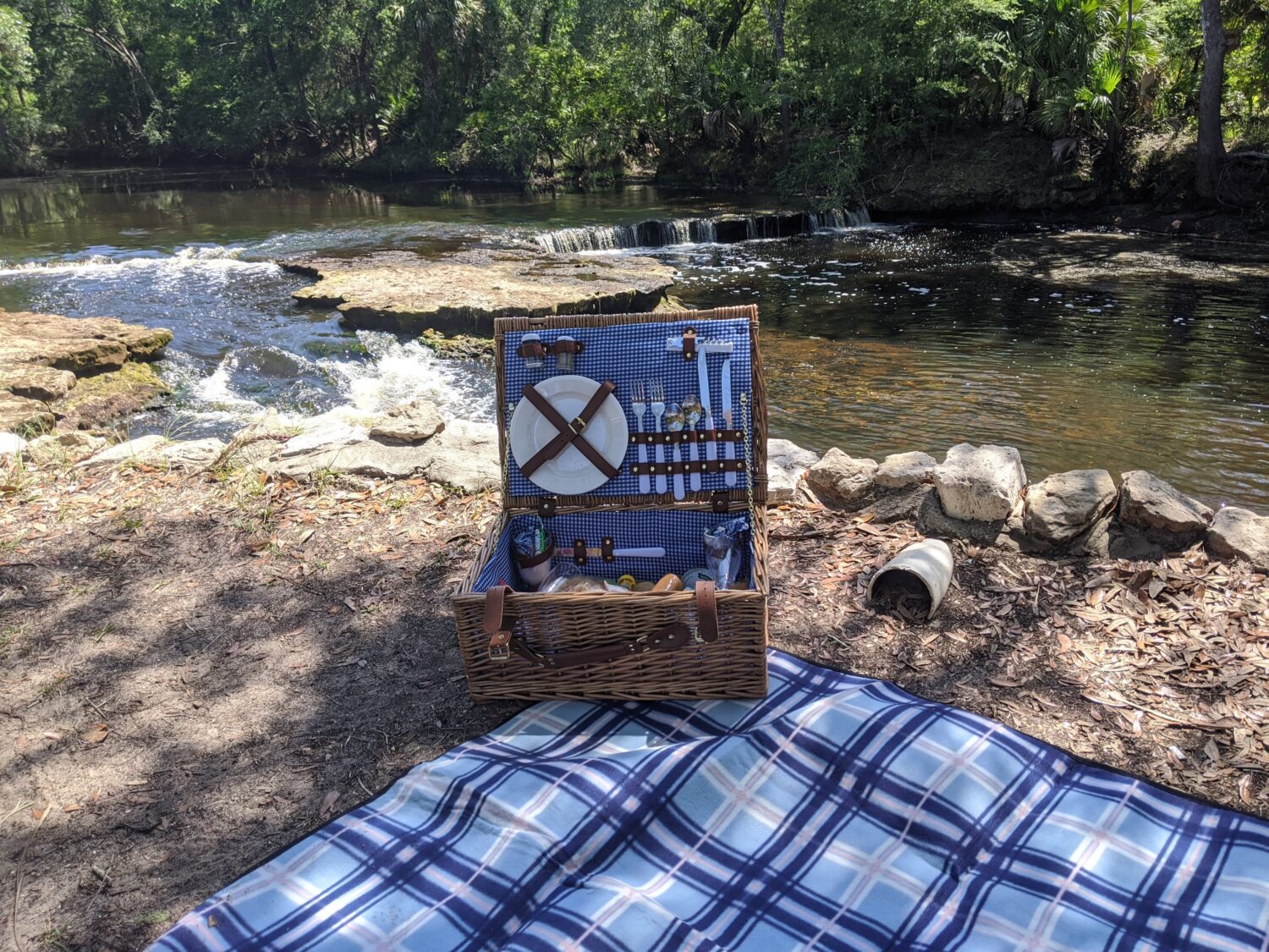 A picnic set up with the beautiful cascading waters of Steinhatchee Falls in the background