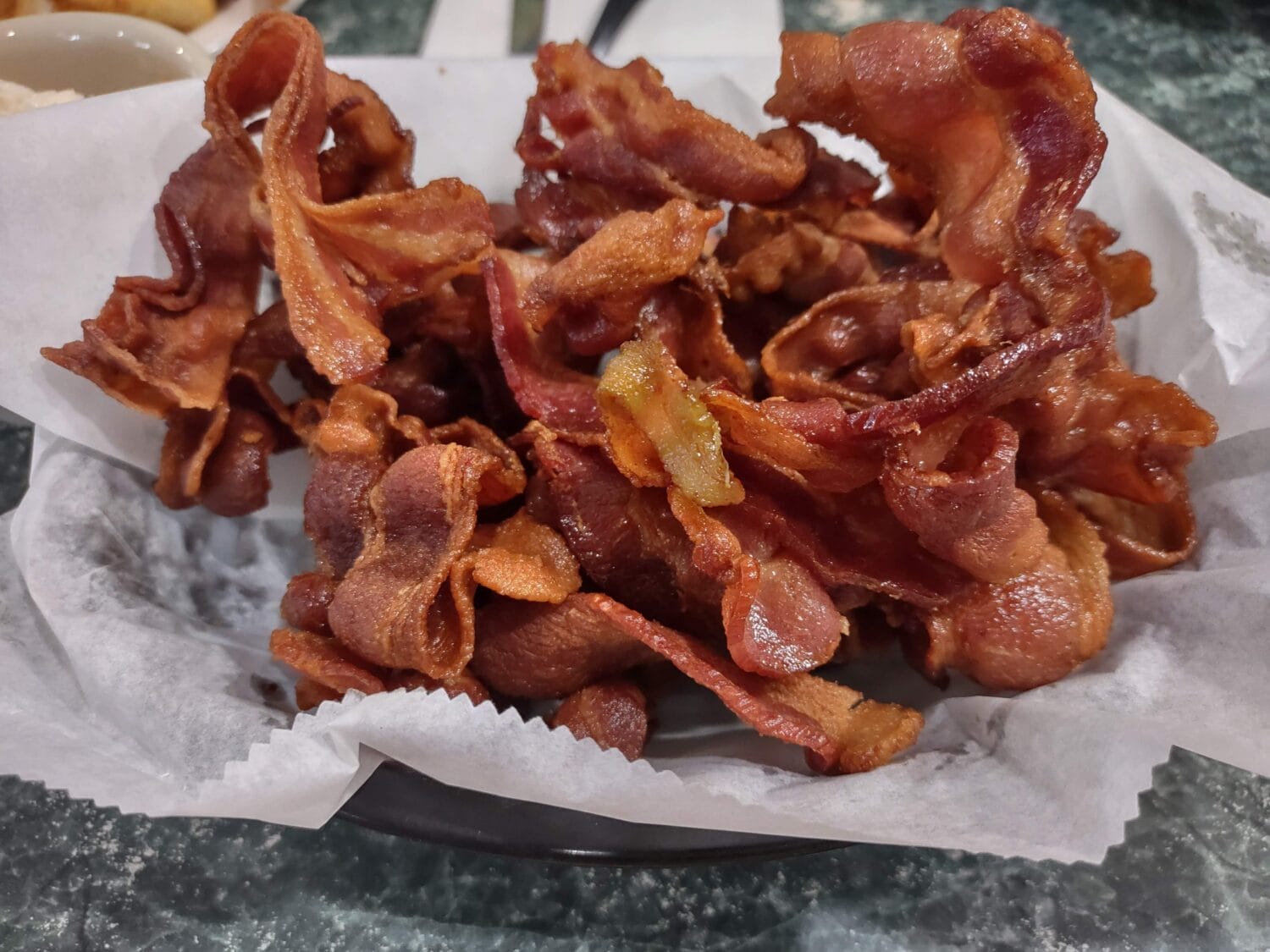 a plate of cispy fried bacon