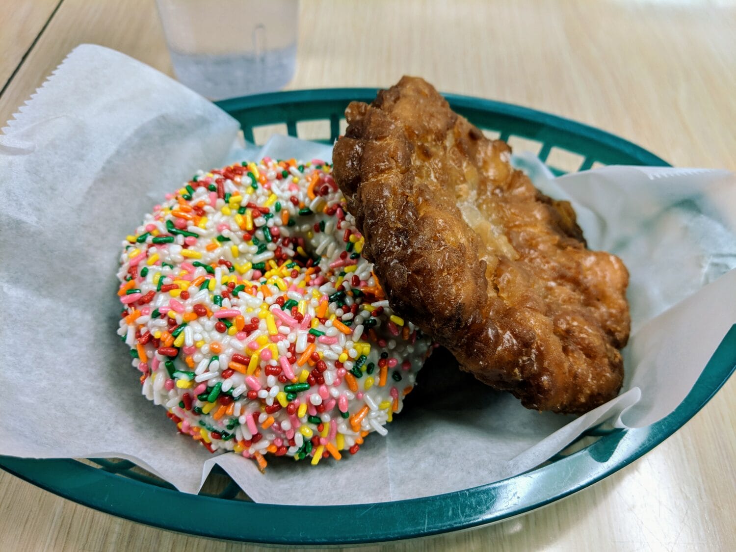 A plate of crispy and colorful sprinkled donuts