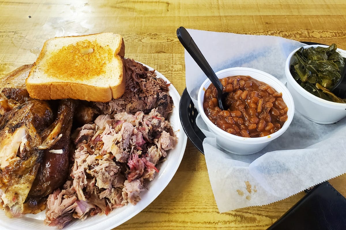a plate of delicious pulled pork with various sides