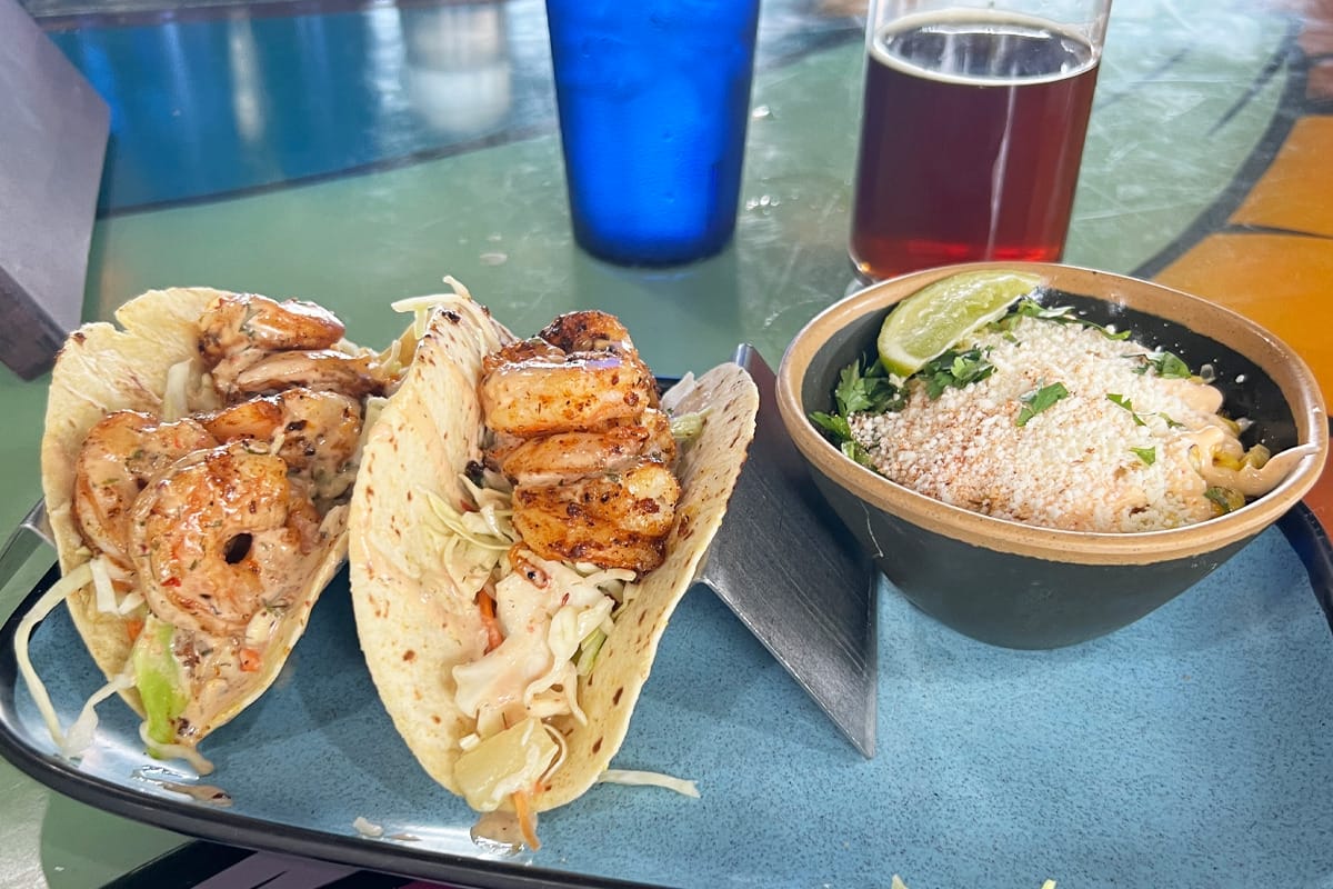 A  plate of delicious tacos and a glass of beer