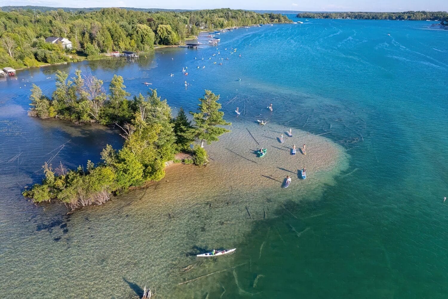 aerial view of elk lake with people enjoying paddleboarding and kayaking on clear, shallow waters