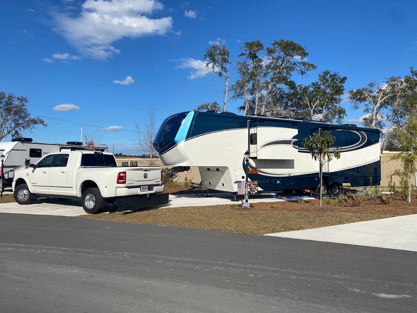 an rv parked at a campsite with a pickup truck in the foreground at keystone heights rv resort