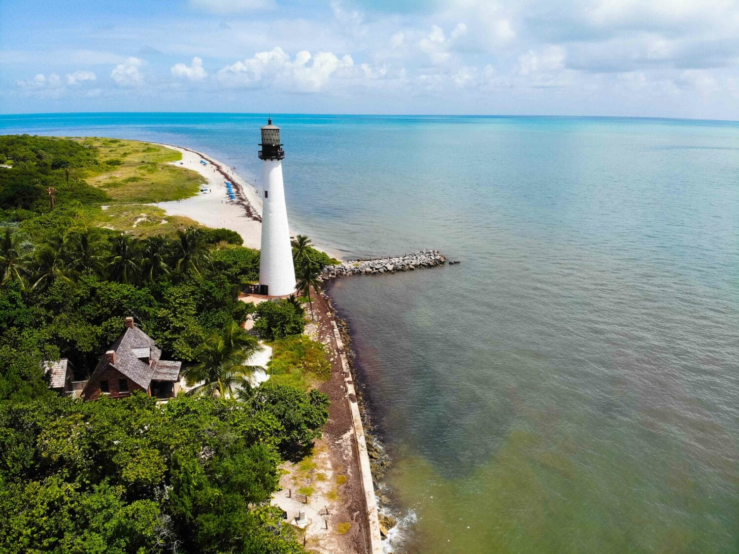 an aerial shot of the lighthouse that also shows its surrounding scenery