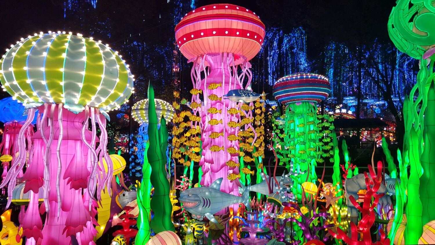 an artistic colorful underwater scene with illuminated jellyfish lanterns