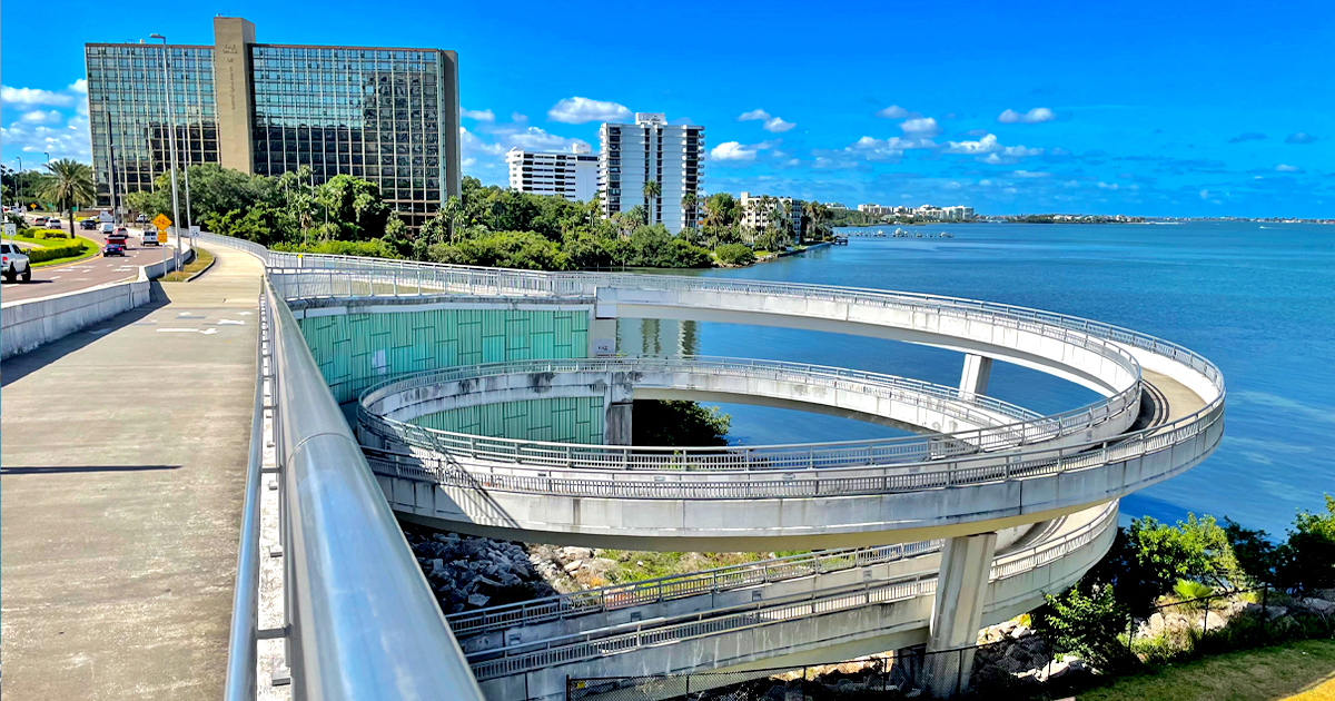 an image of the memorial causeway bike trail on the bridge with views of the water and a circular path