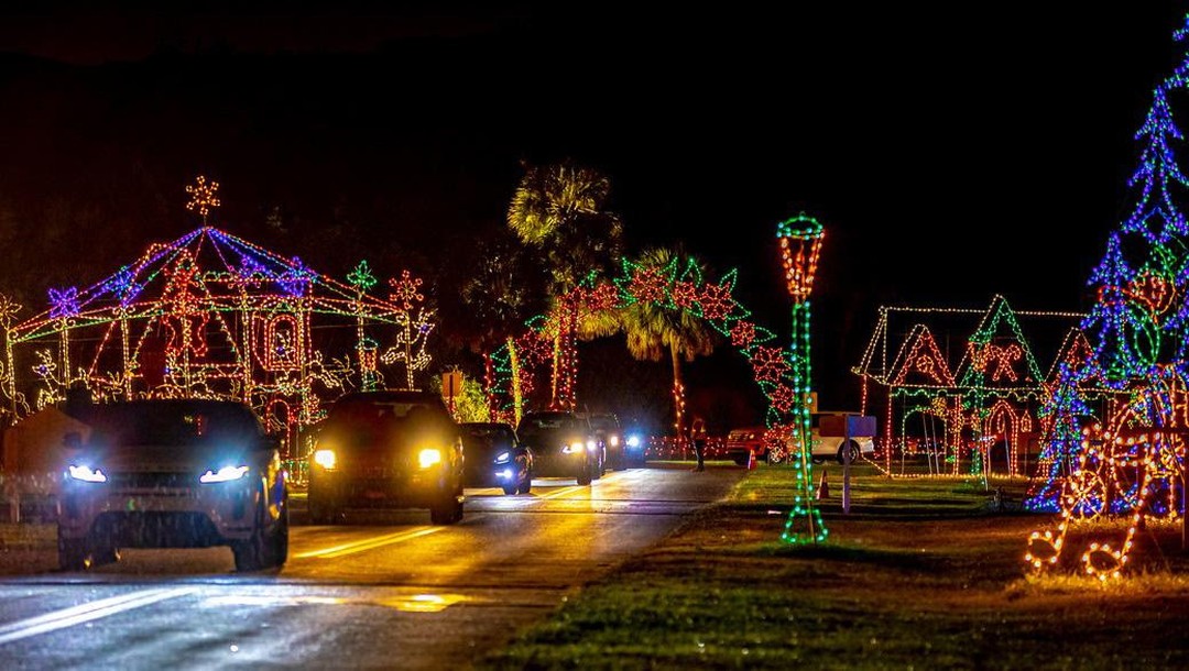 cars passing by the vibrant streets adorned with holiday lights