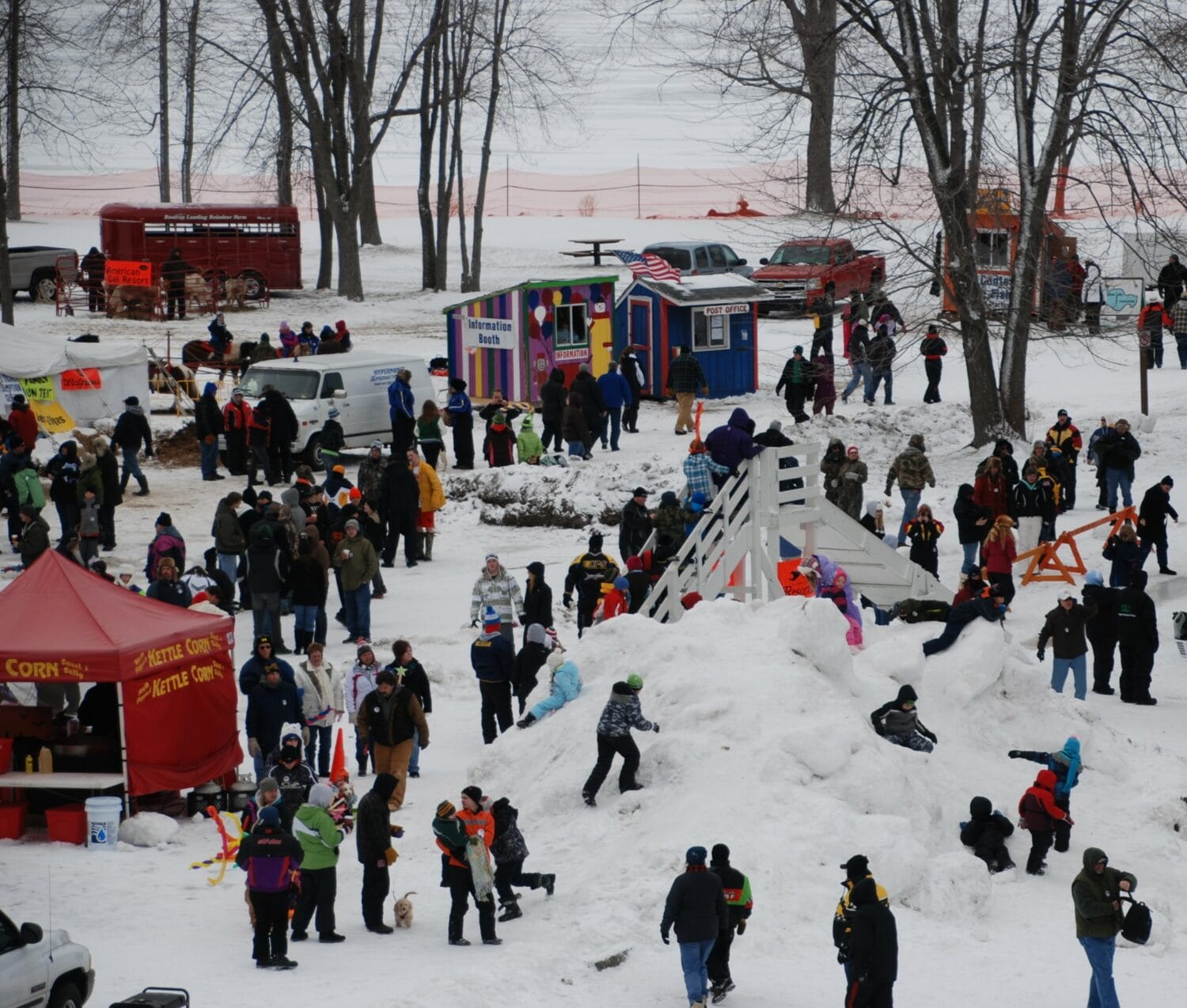 families and participants enjoy tip up town, with activities like a snow slide and various colorful booths
