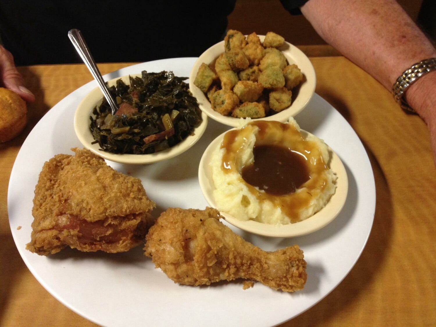fried chicken with mashed potatoes collared greens and fried okra on the side