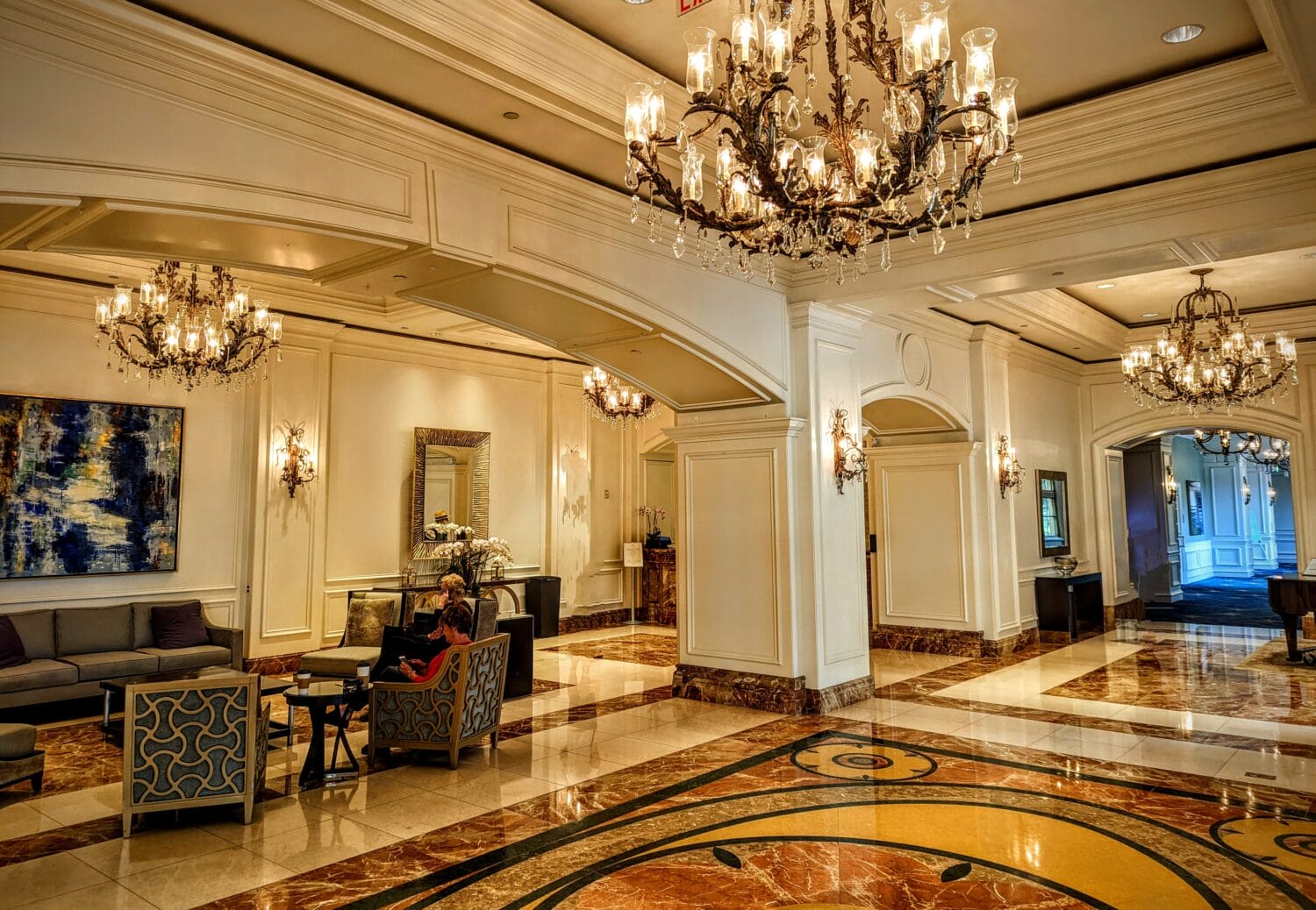 lobby of the ritz carlton sarasota with beautiful hanging chandeliers and marble floor