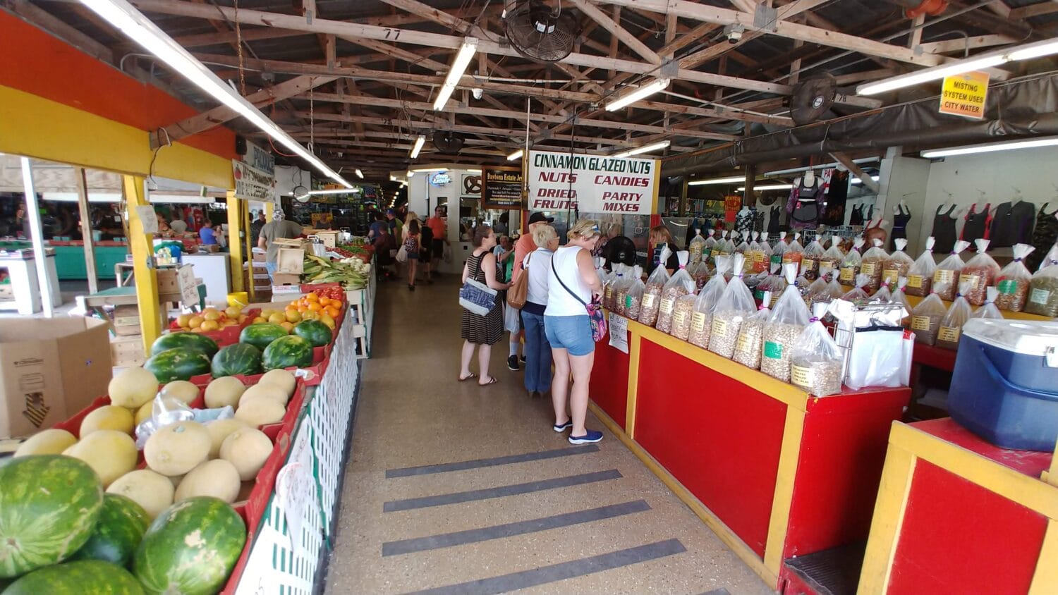 people shopping at the nuts section inside the flea market