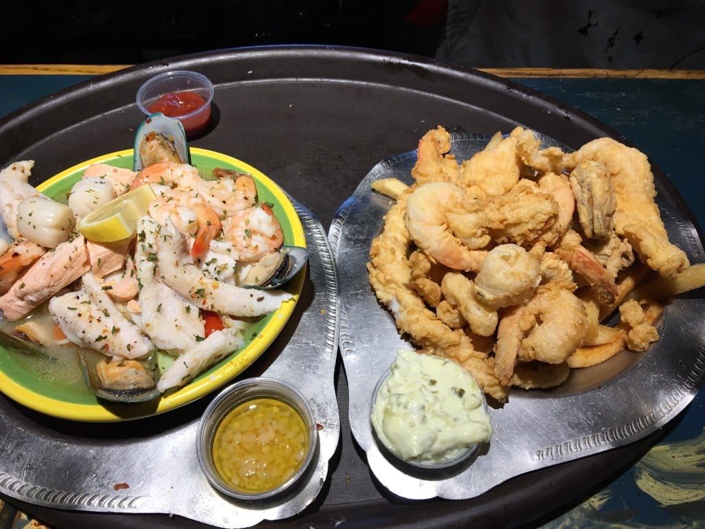 Plates of yummy fresh and fried seafood.