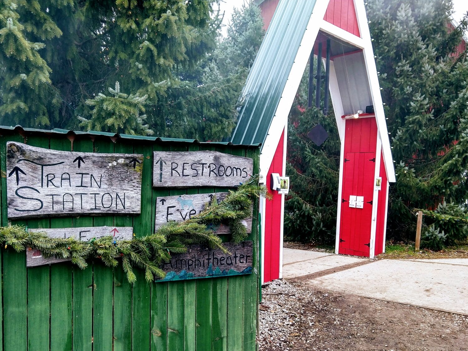 rustic wooden signs festooned with festive greenery direct visitors to various attractions at peacock road family farm