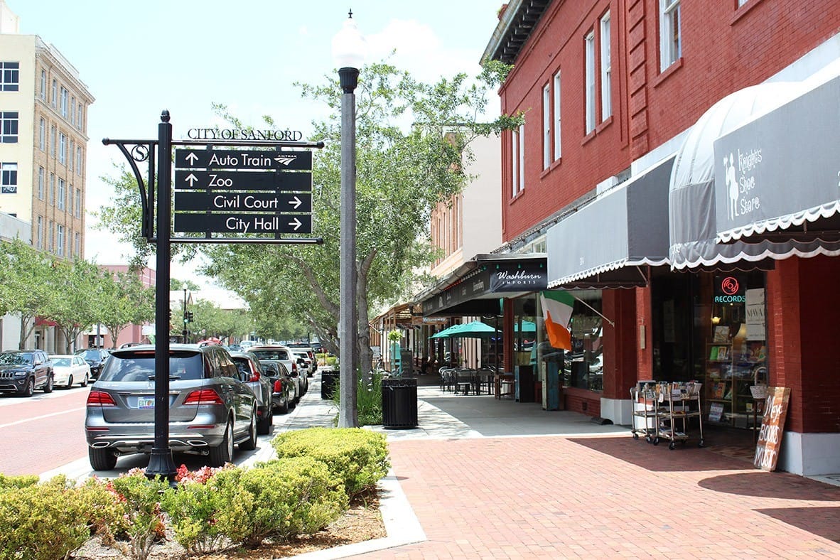 sidewalk in sanford with a signage of landmarks and stores lined up on the side