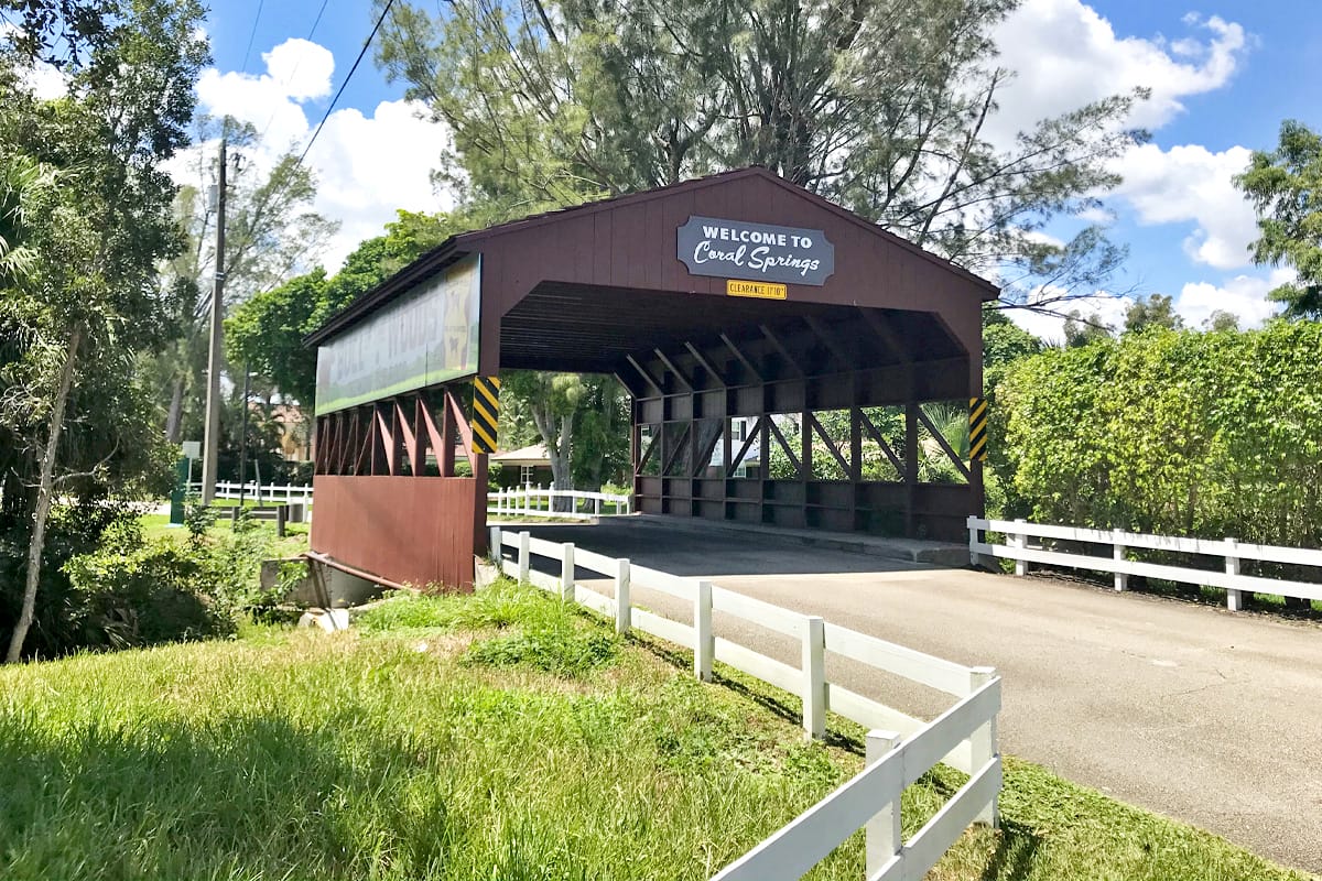 the coral springs covered bridge, the first permanent structure built within the city of coral springs