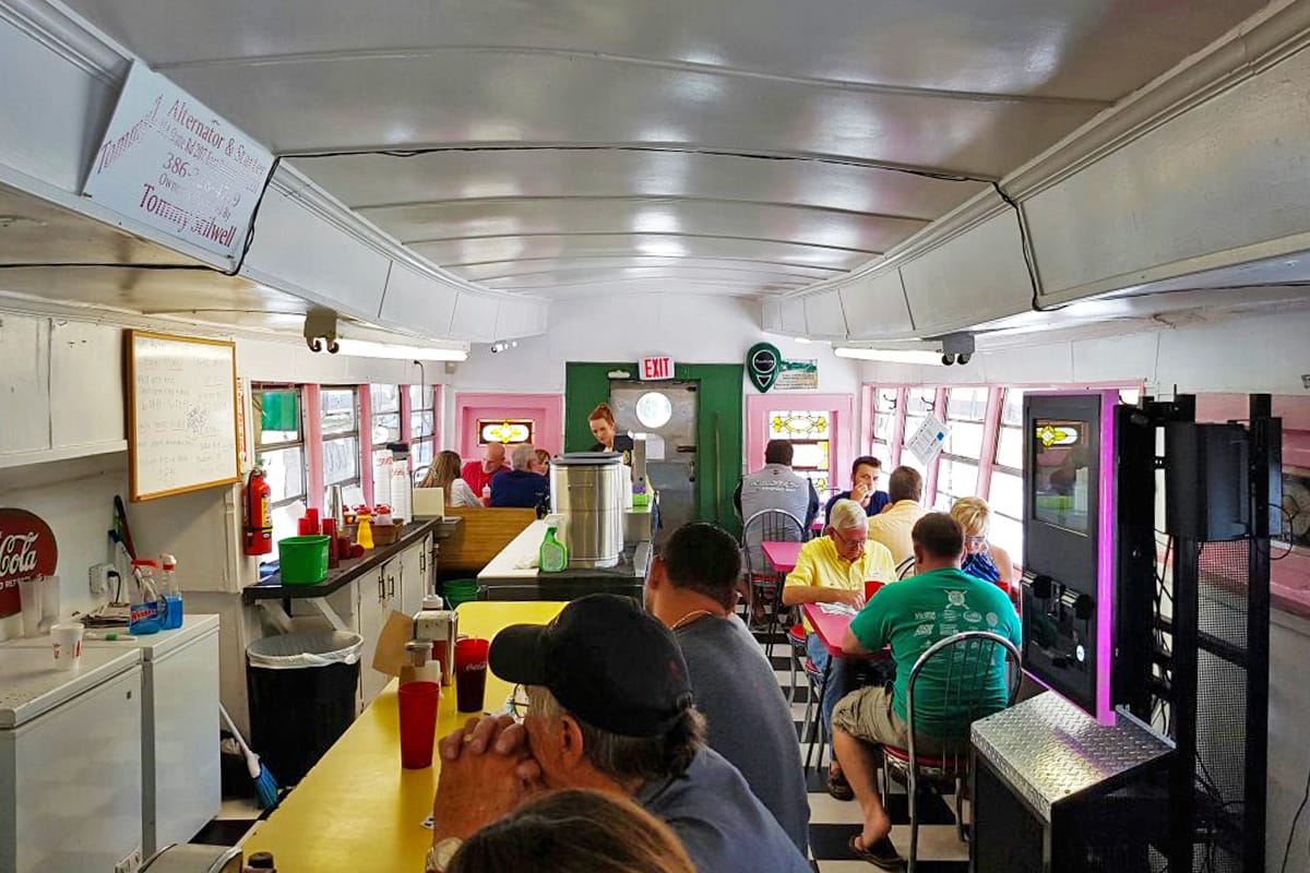 The cozy interior of the diner with customers enjoying their meals.