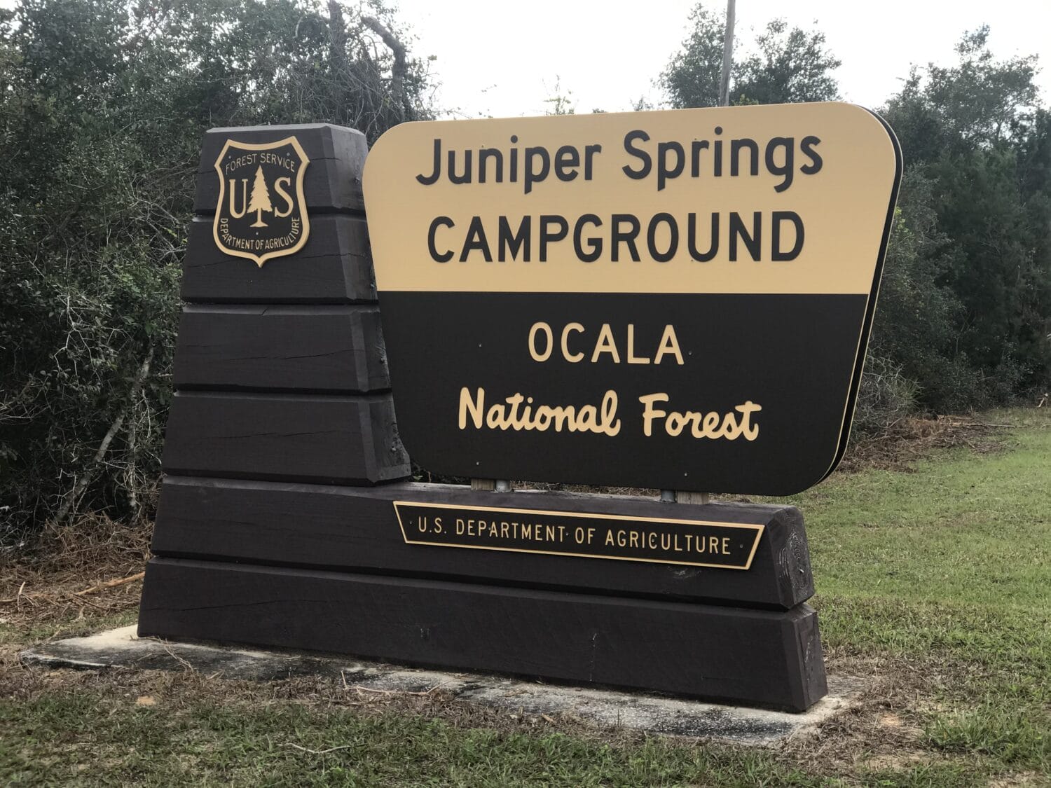 the entrance sign of juniper springs campground in ocala national forest featuring bold lettering