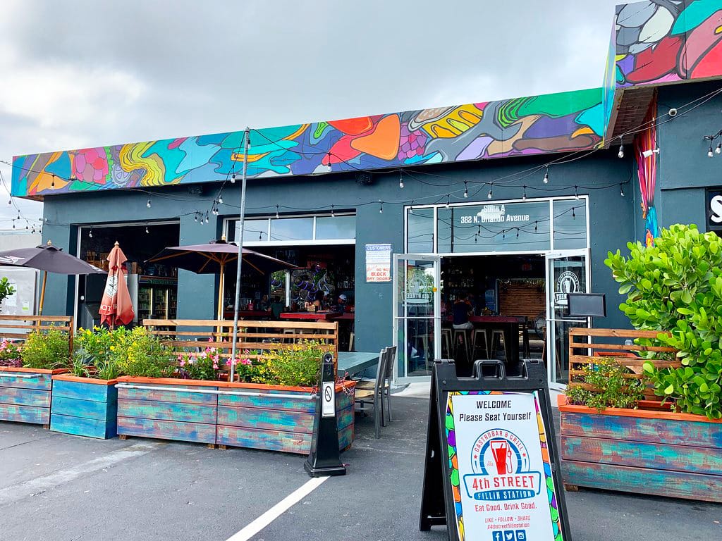 The outside of the restaurant with colorful painting on the wall