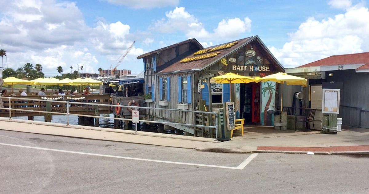 the rustic bait house restaurant with outdoor seating by the waterfront