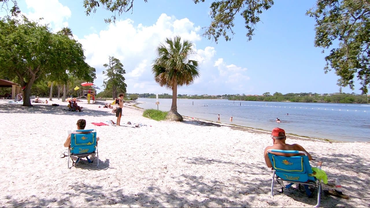 Tourists relaxing on the white sand beach of Anclote Key Preserve