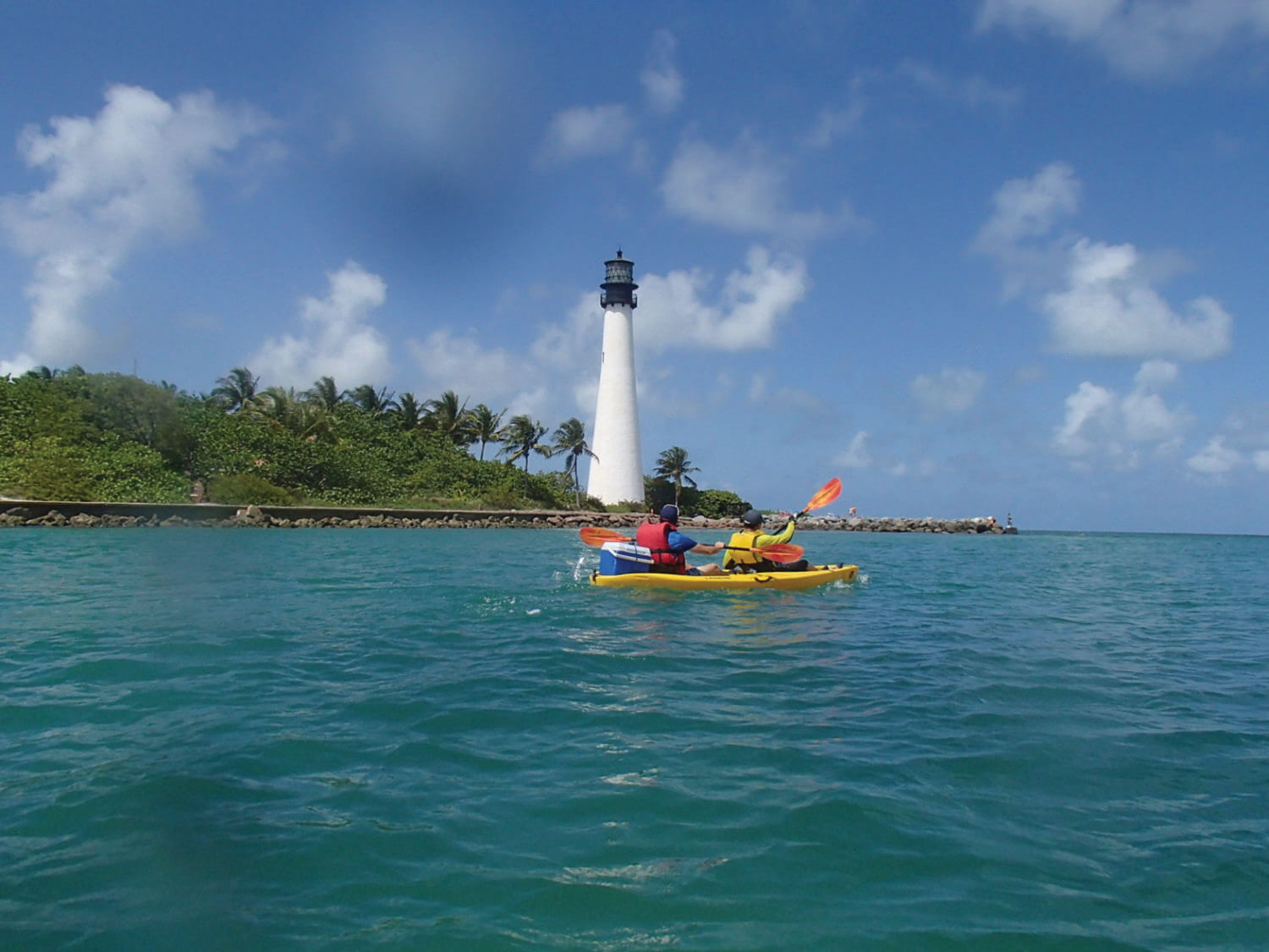 two people kayaking near the lighthouse