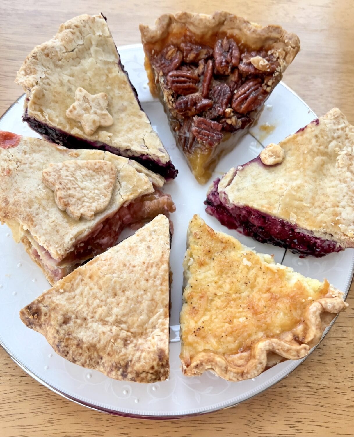 various flavors of pies on a plate served in slices