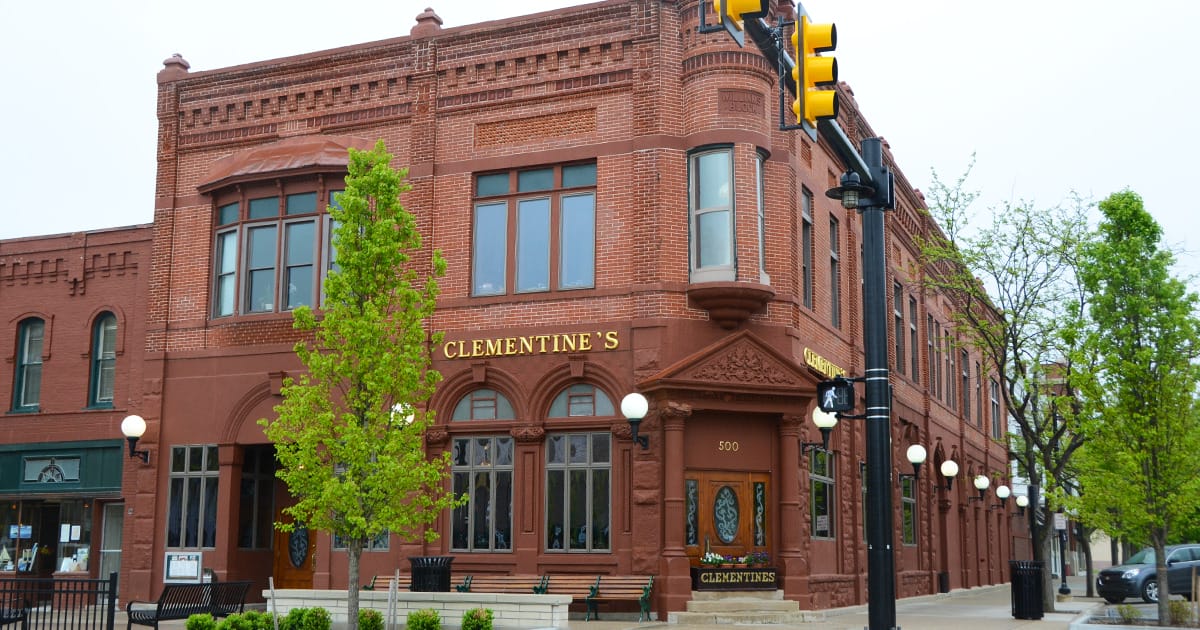 the exterior of clementine's, a brick building at the corner of a street in the quaint downtown area of south haven