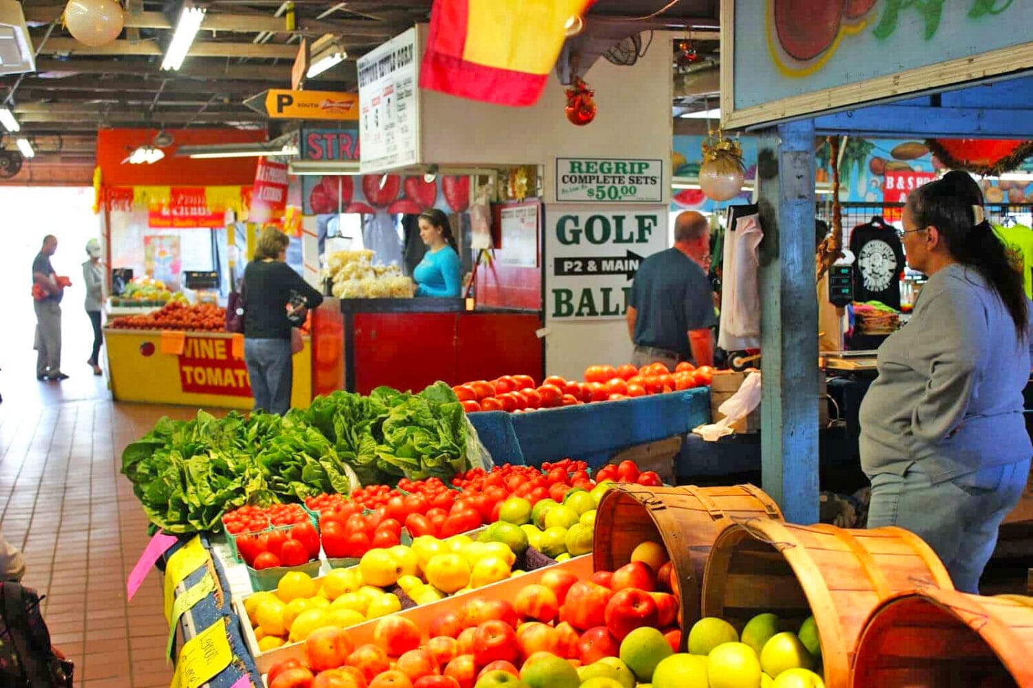 the fruit and vegetables stand inside the market with fresh produce on display