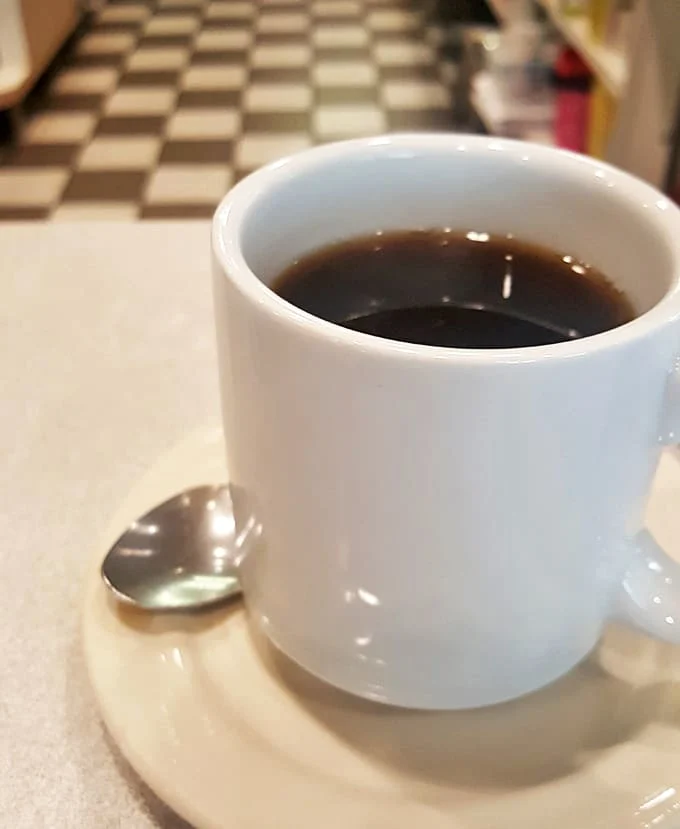 The coffee comes in sturdy mugs that feel like old friends &ndash; hot, strong, and reliable without any fancy pretensions.