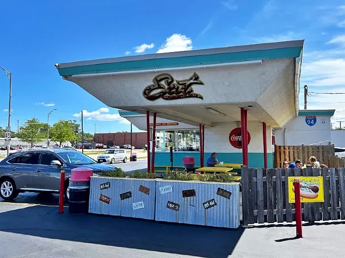 Cruise into flavor town! This drive-in setup isn't just a meal but a time machine. Grab a seat and let the good times (and tasty bites) roll!