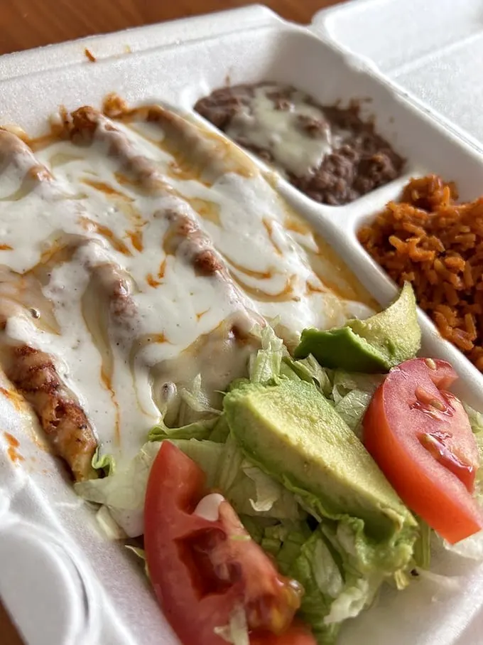 Enchiladas that could make a grown person weep with joy. Smothered in sauce, loaded with cheese—it's comfort food that gives you a warm, spicy hug.
