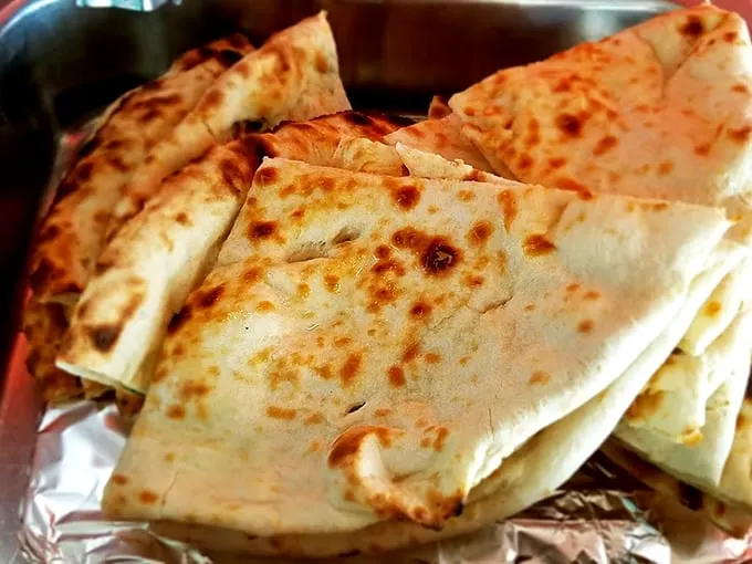 Pillowy perfection! This naan is so fluffy and charred, it's the ideal vehicle for scooping up every last drop of curry.