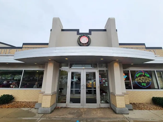 Step back in time! This retro facade is like a portal to the '50s, complete with chrome trim and a neon sign that screams "Elvis might eat here!"